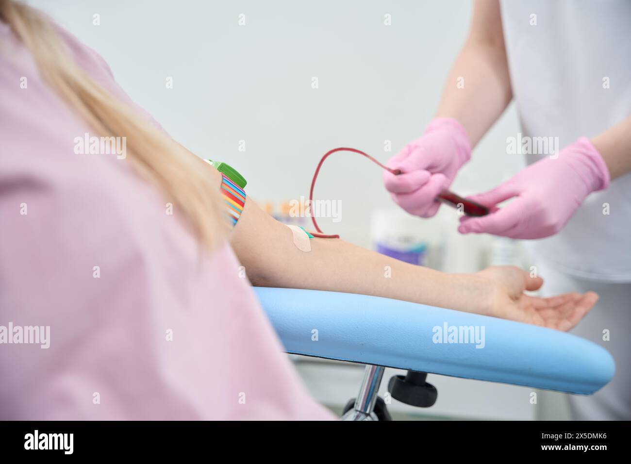 Qualified therapist connecting an IV, performing blood transfusion procedure Stock Photo - Alamy
