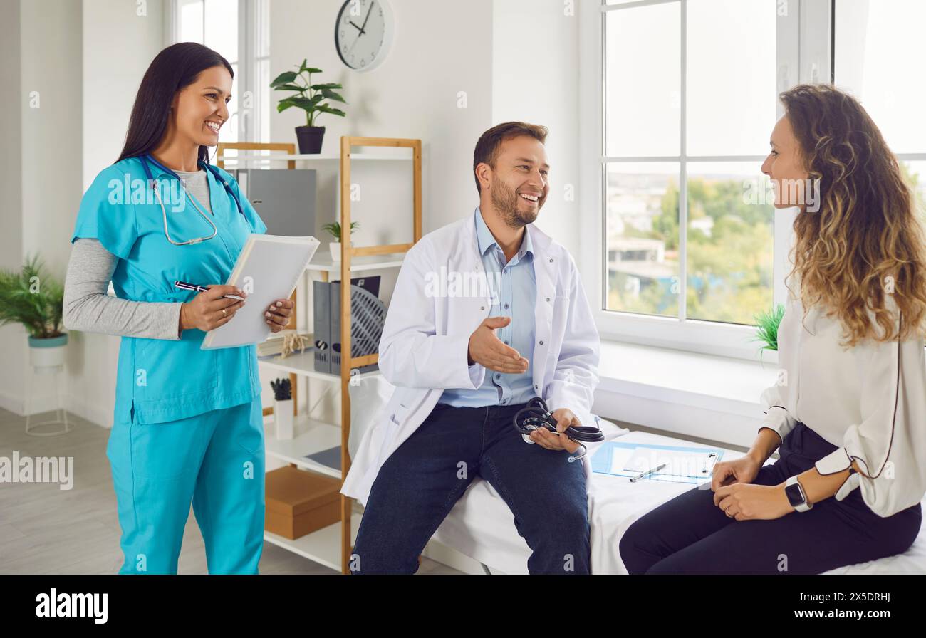 Caring Doctor and Nurse Engage with Patient Stock Photo - Alamy