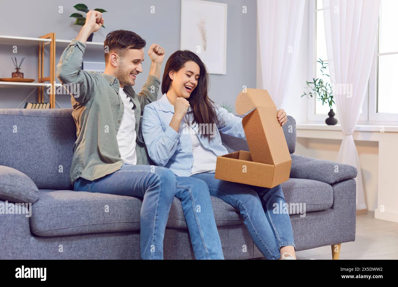 Woman excitedly opens box new hi-res stock photography and images - Alamy
