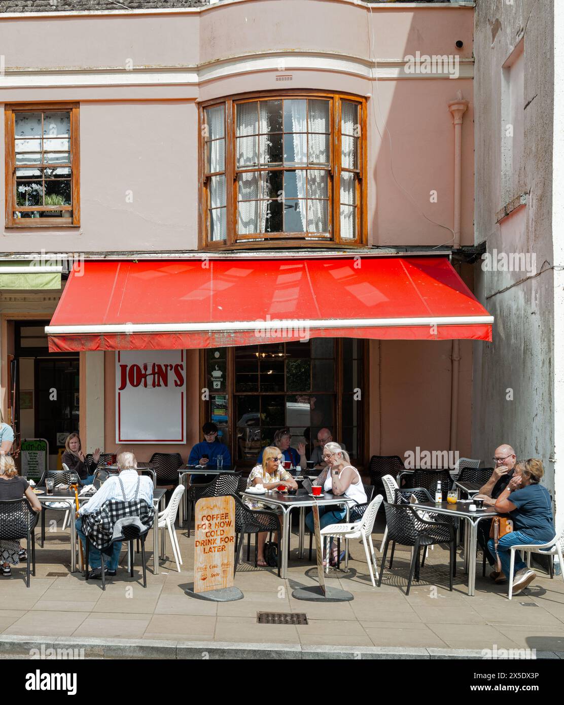 People sitting outside a Dawlish cafe eating and drinking in Devon ...