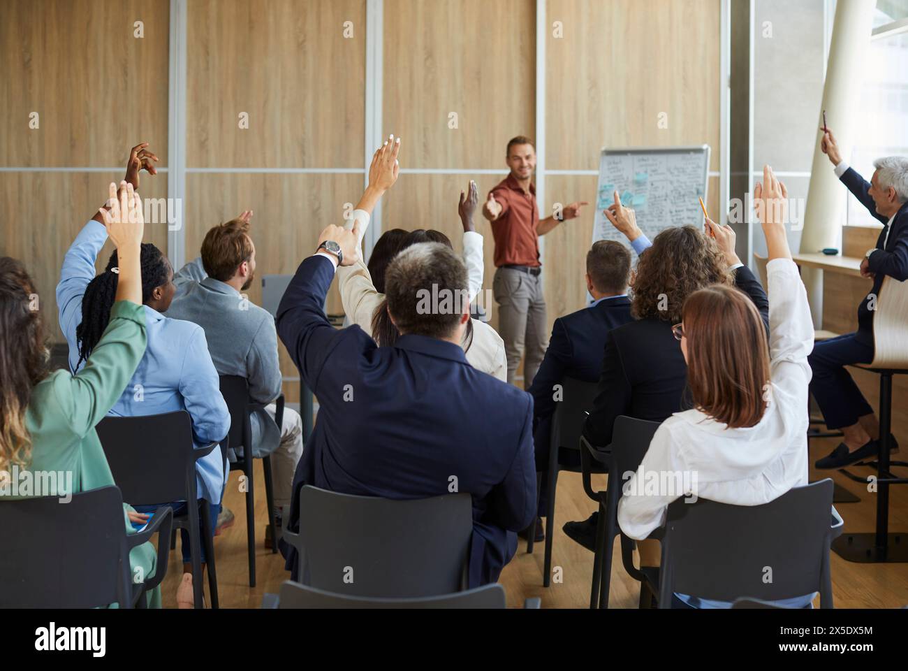 People colleagues raising hands to ask questions during business ...