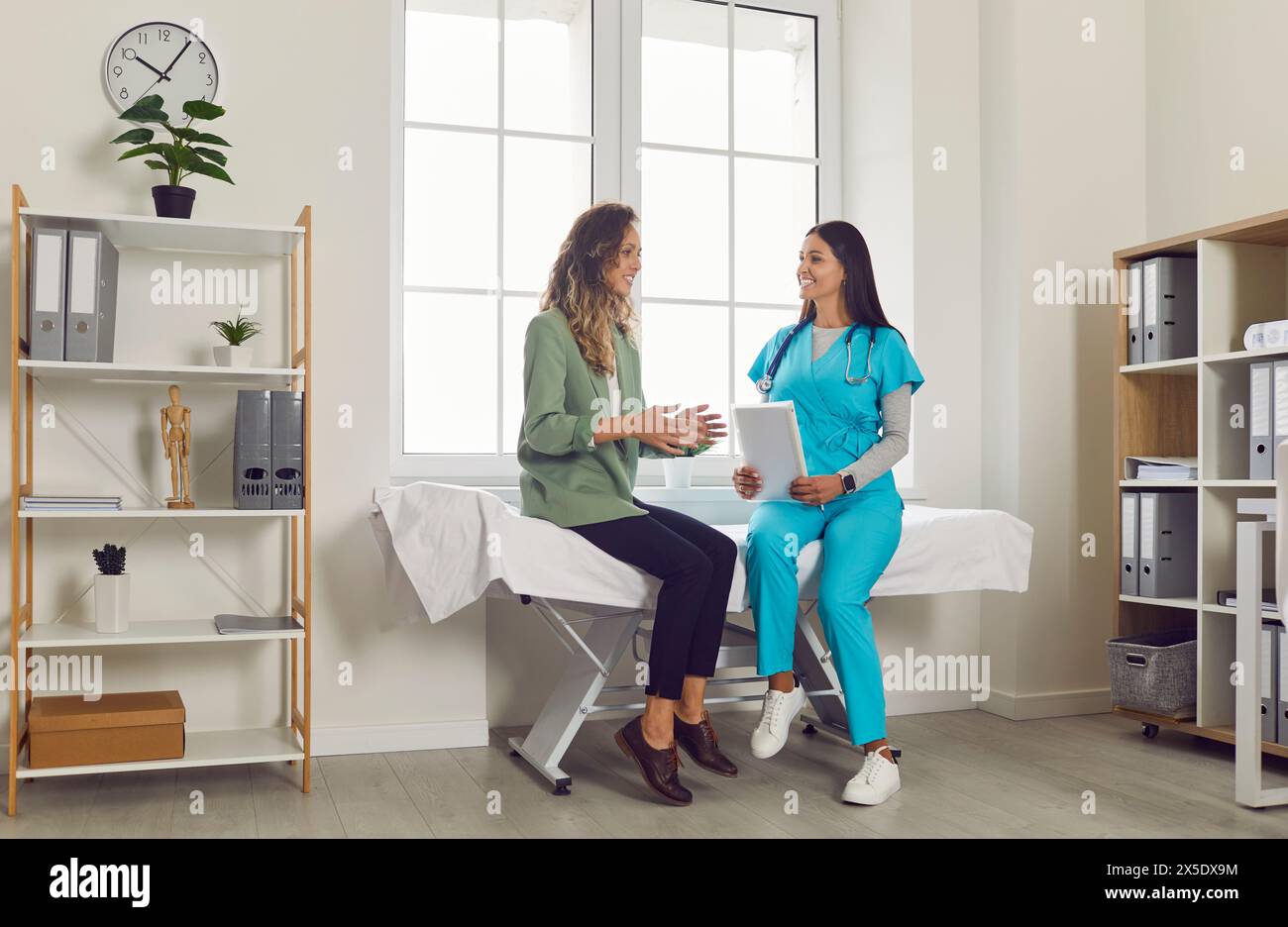 Positive Female Doctor Engaging with Patient in Hospital Room Stock ...
