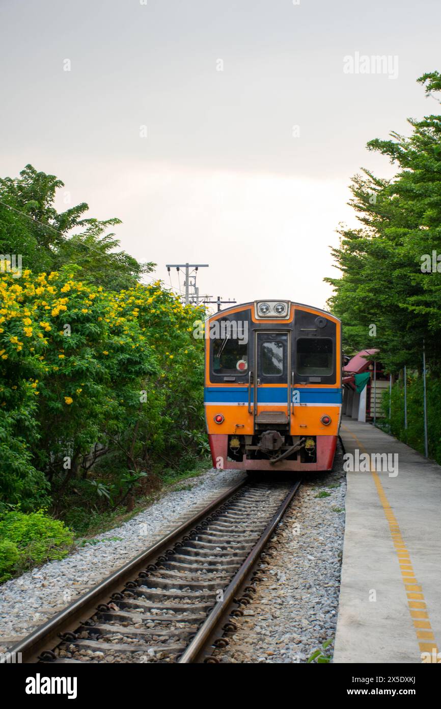 Thai local train on railway with green trees, Bangkok, Thailand Stock ...