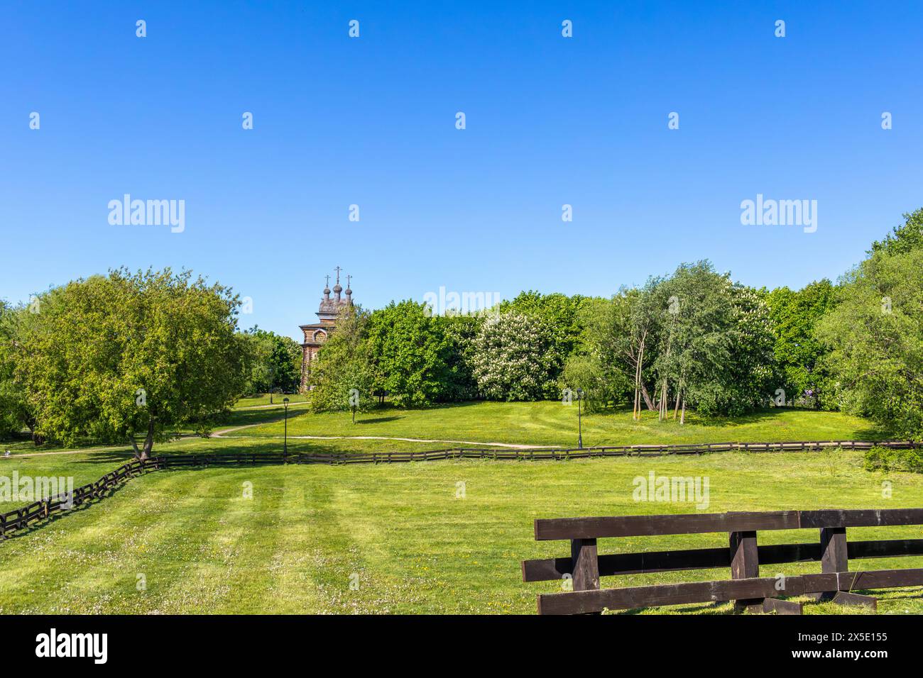 Spring green landscape with wooden temple and fence Stock Photo - Alamy