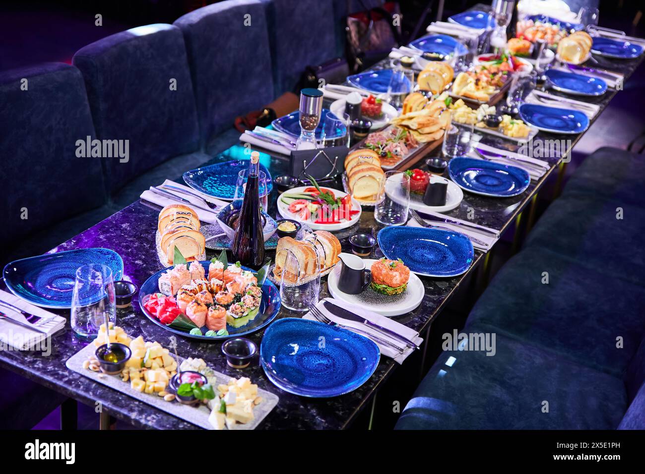 Served banquet table with appetizers, salads and drinks in a nightclub ...