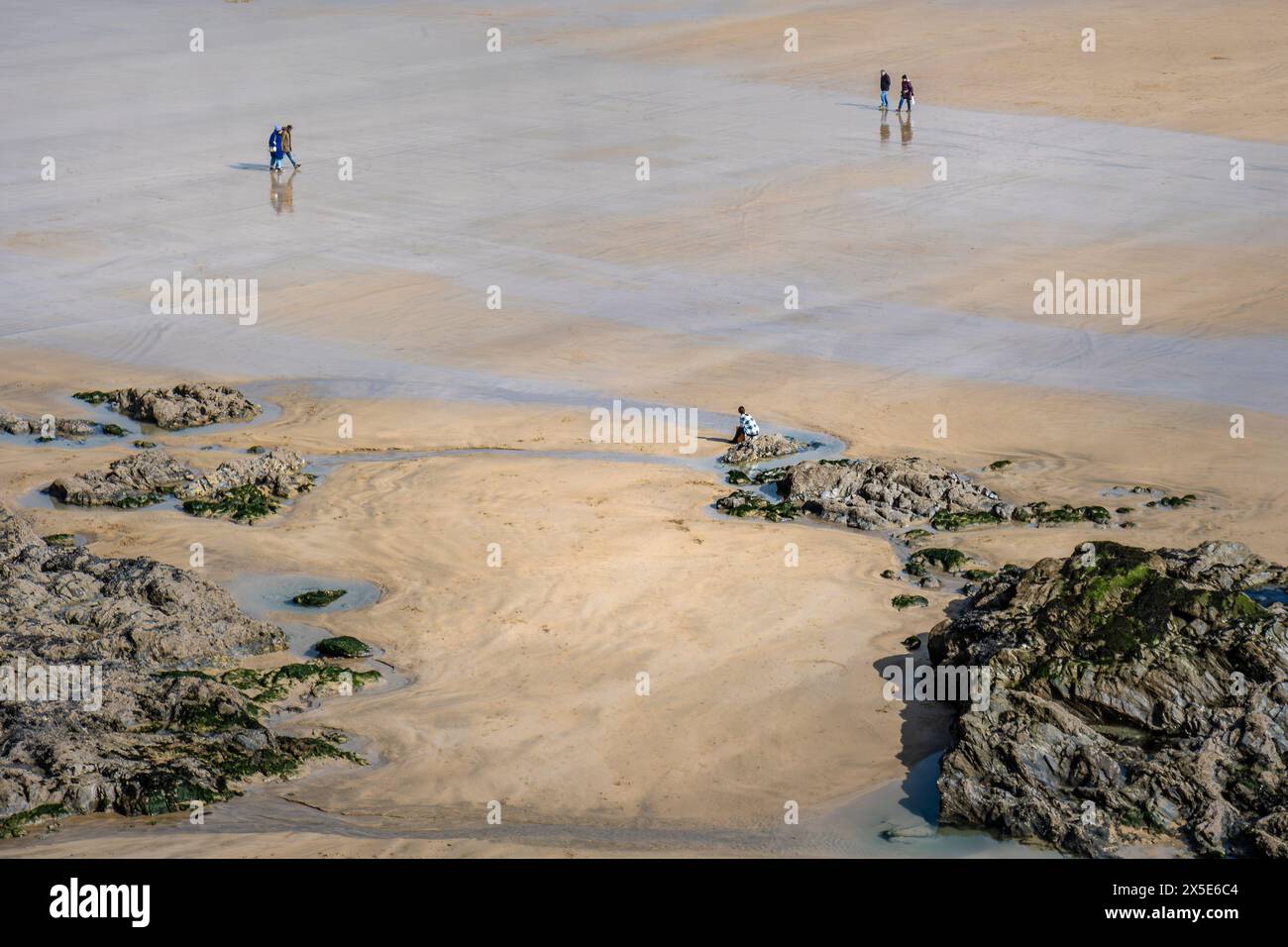 People on Towan beach at low tide In Newquay in Cornwall in the UK ...