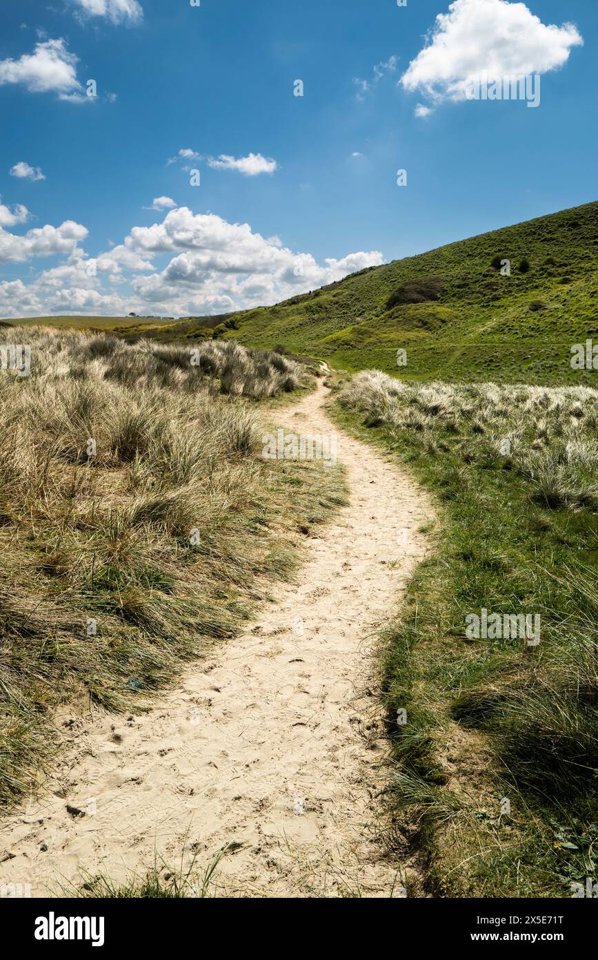 A sandy footpath in a shallow valley in Newquay in Cornwall in the UK ...