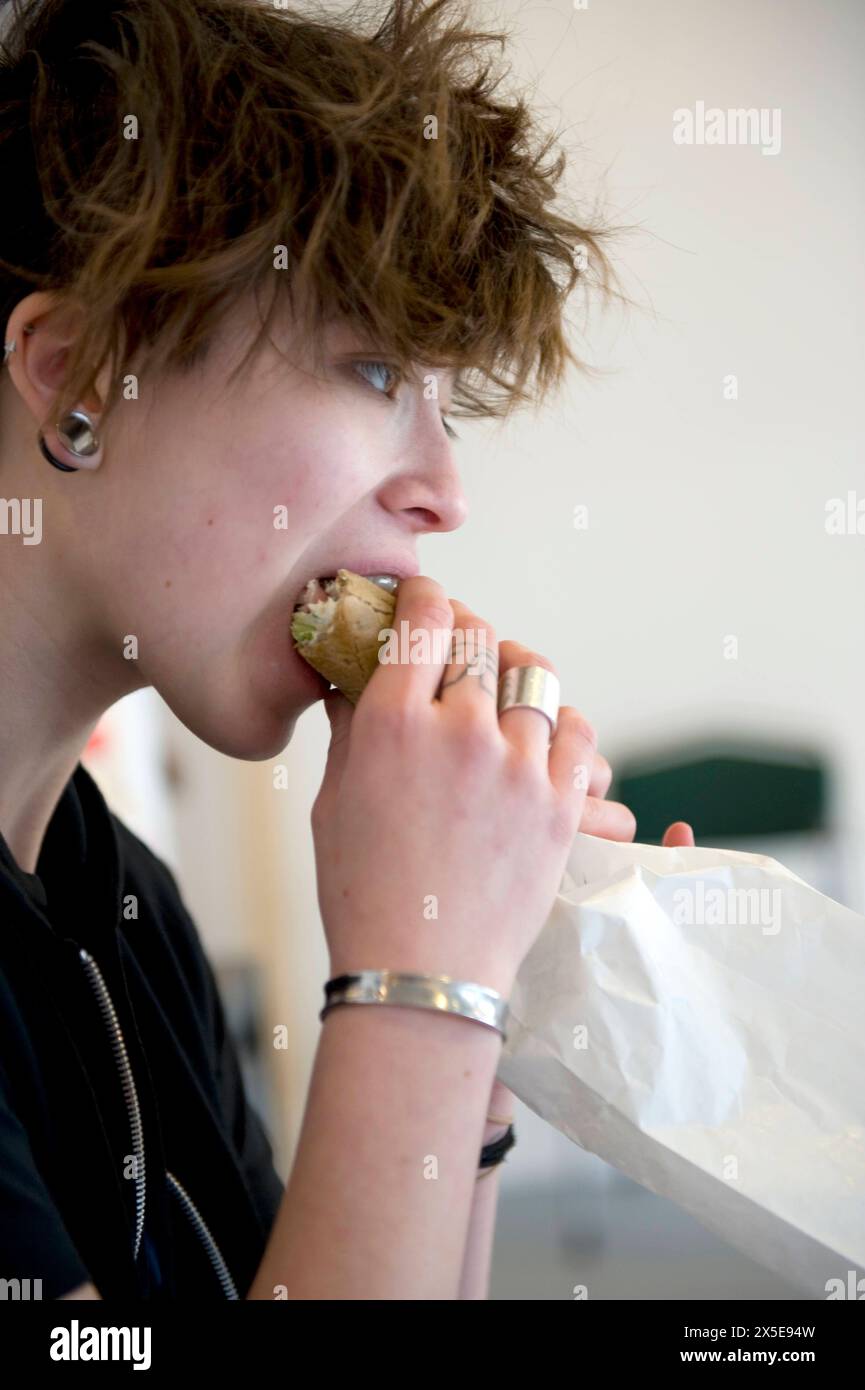 Girl Eating Sandwich Young ault, female student, eating a sandwich at ...