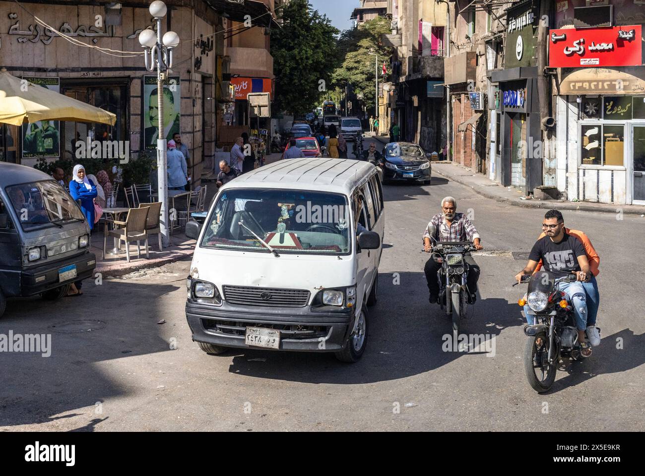 Typical street corner scene in Cairo, Egypt. The roads are often busy with cars, vans and bikes ...