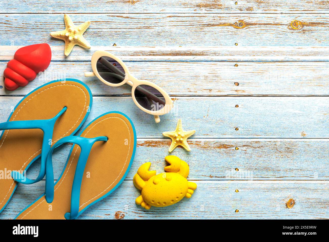 Top view of flip flops,sunglasses, starfish and beach toys with copy ...