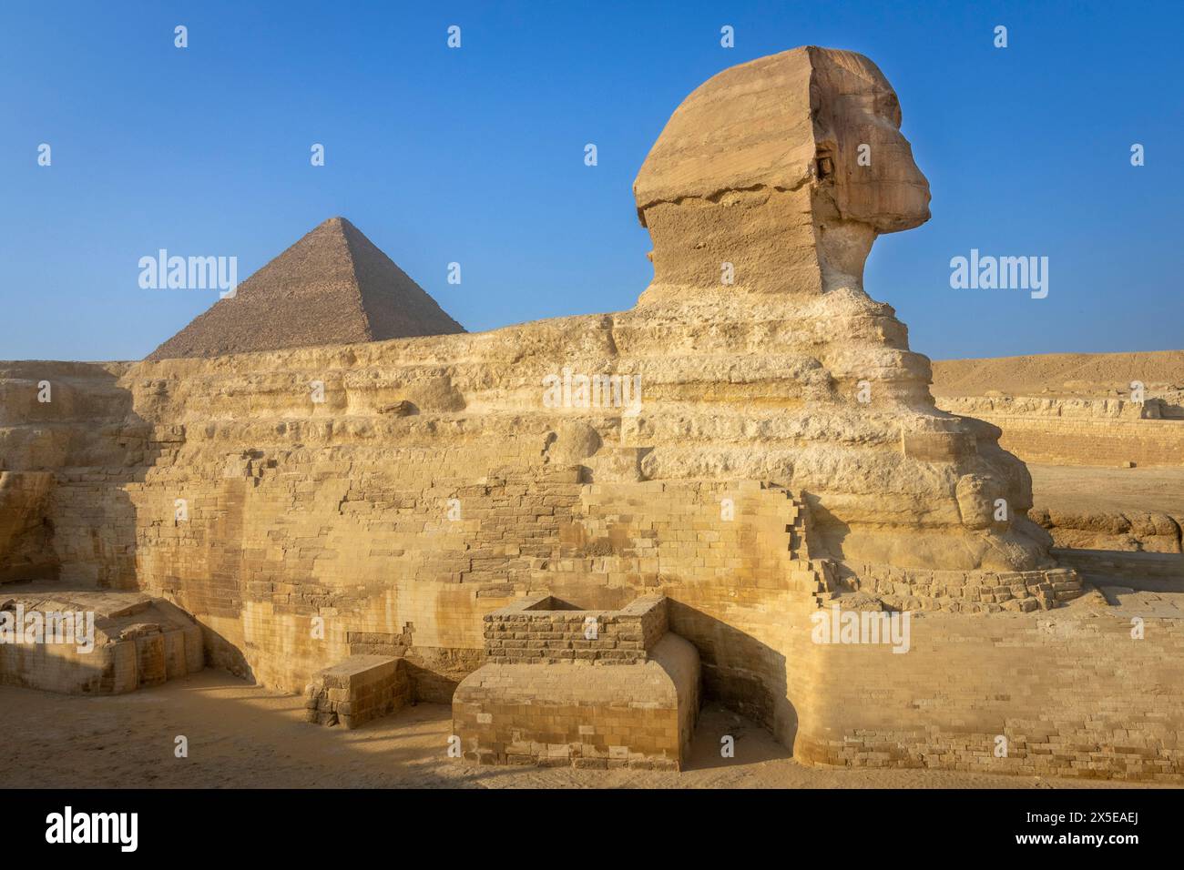 The Great Sphinx with the pyramid of Khufu in the background. The world-famous Giza Plateau is ...