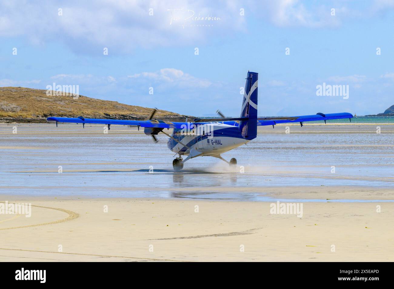 A loganair DHC-6 Twin Otter taking off from Barra Airport in the Outer ...