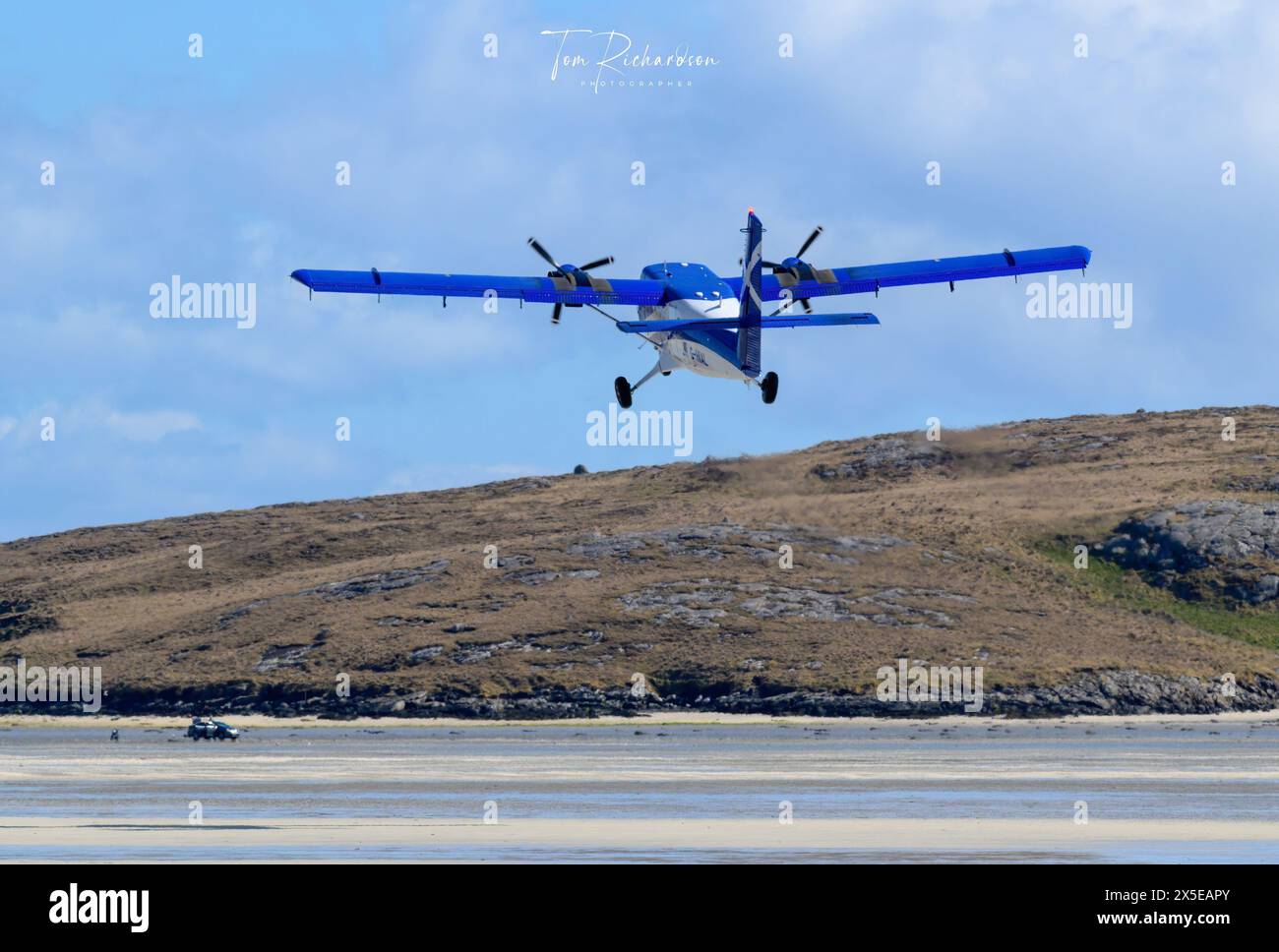 A loganair DHC-6 Twin Otter taking off from Barra Airport in the Outer ...