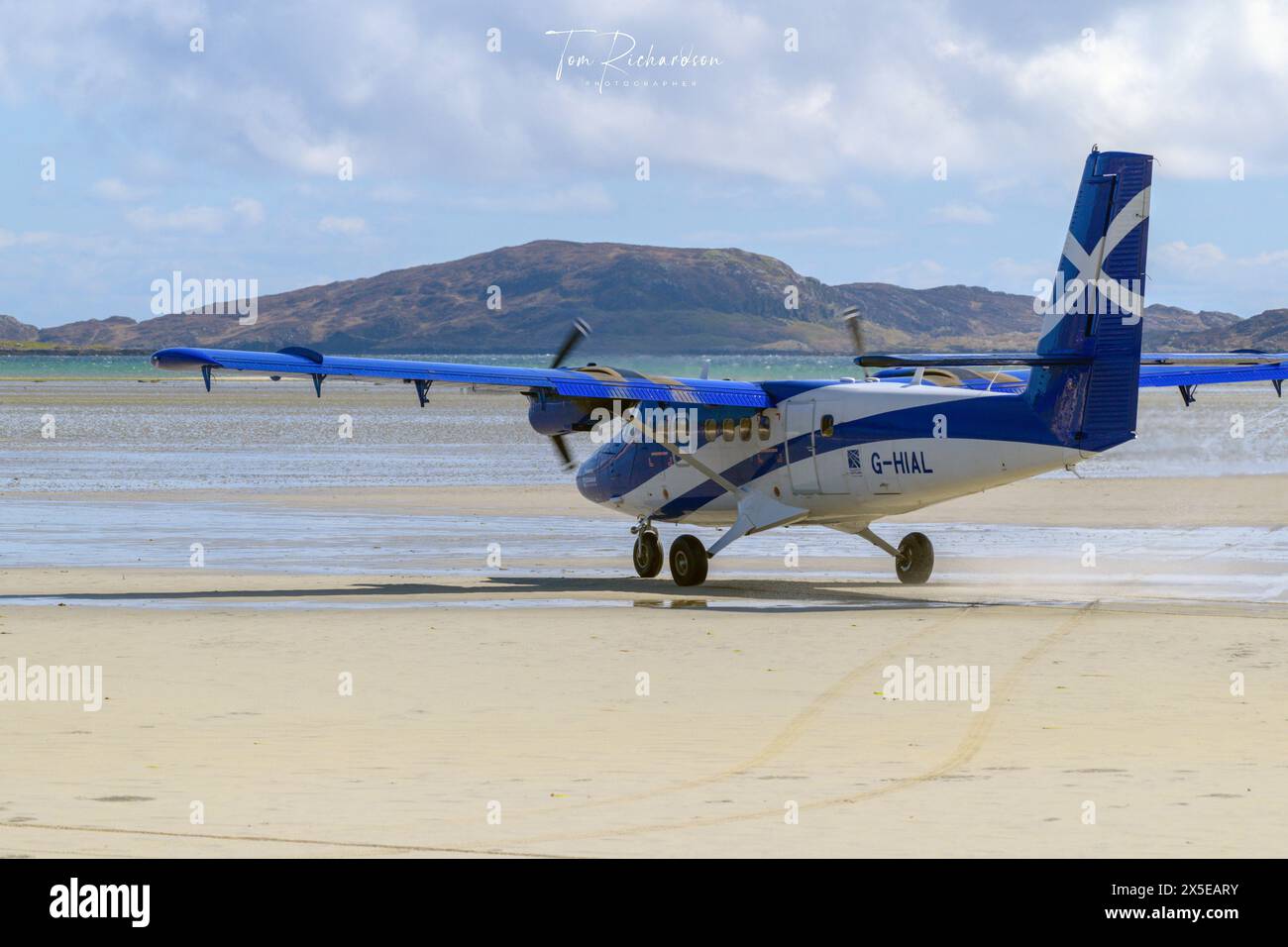 A Loganair DHC-6 Twin Otter taking off from Barra Airport in the Outer ...