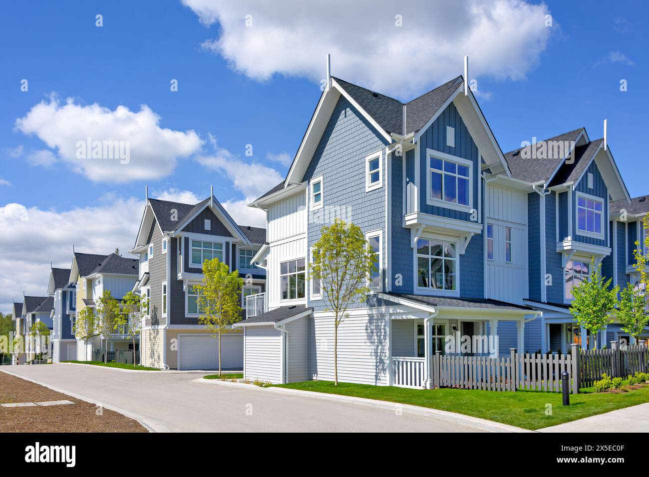 A perfect neighborhood. Brand new townhouses district on blue sky ...