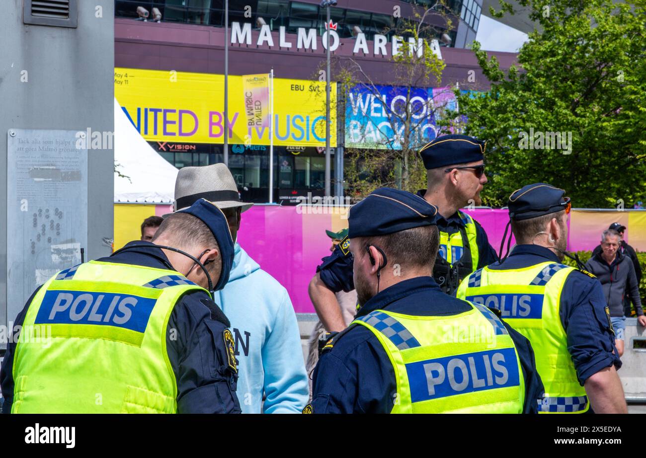 09 May 2024, Sweden, Malmö: Police officers control people in front of ...