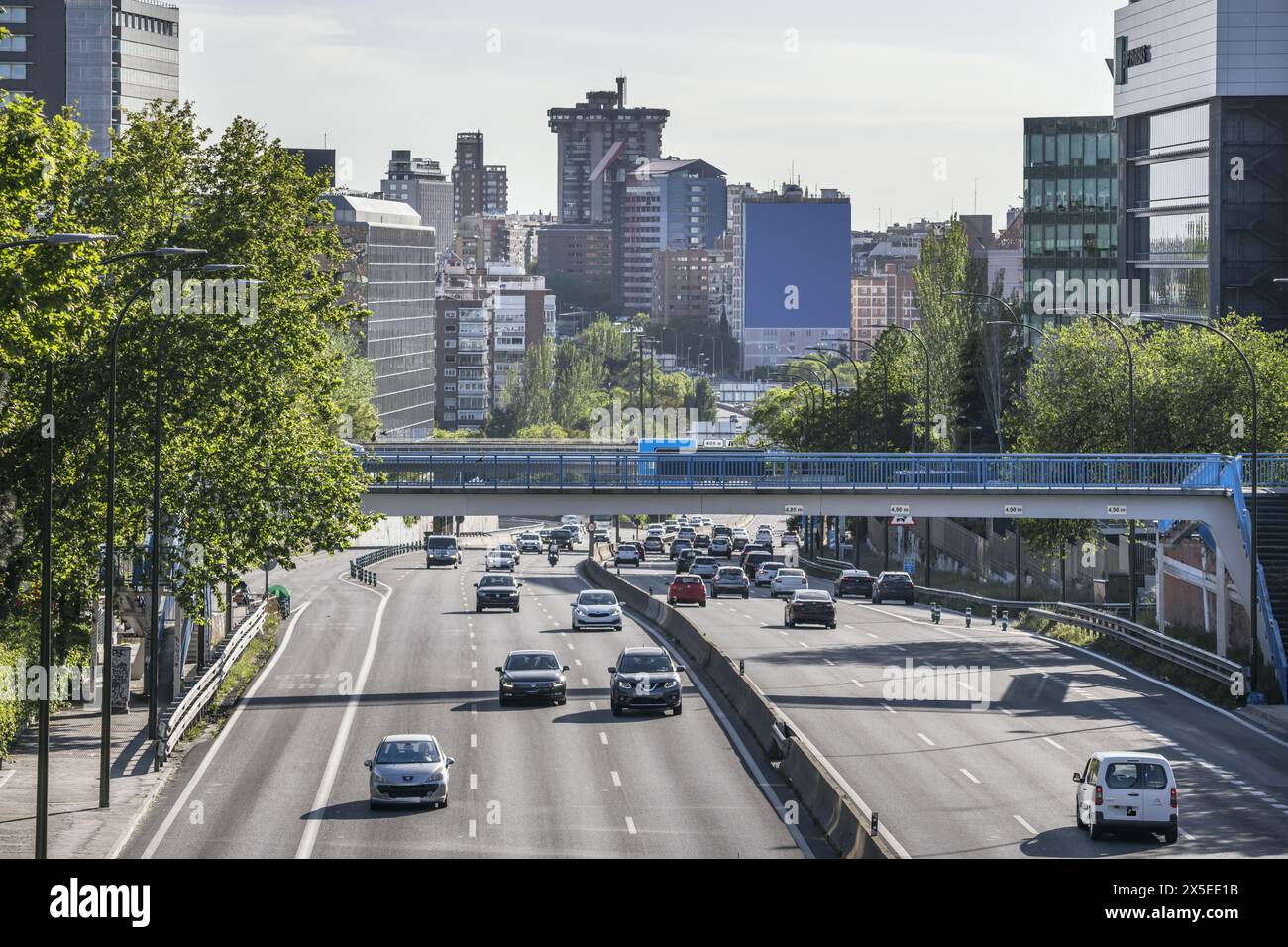 Urban entrance road to Madrid and a large pedestrian walkway over the ...
