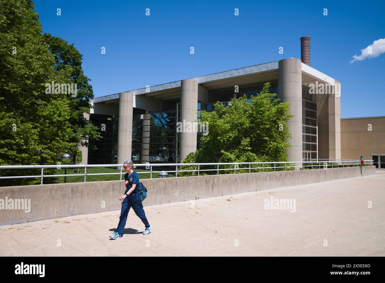 A student walks past the Power Center for the Performing Arts on the campus of The University of ...