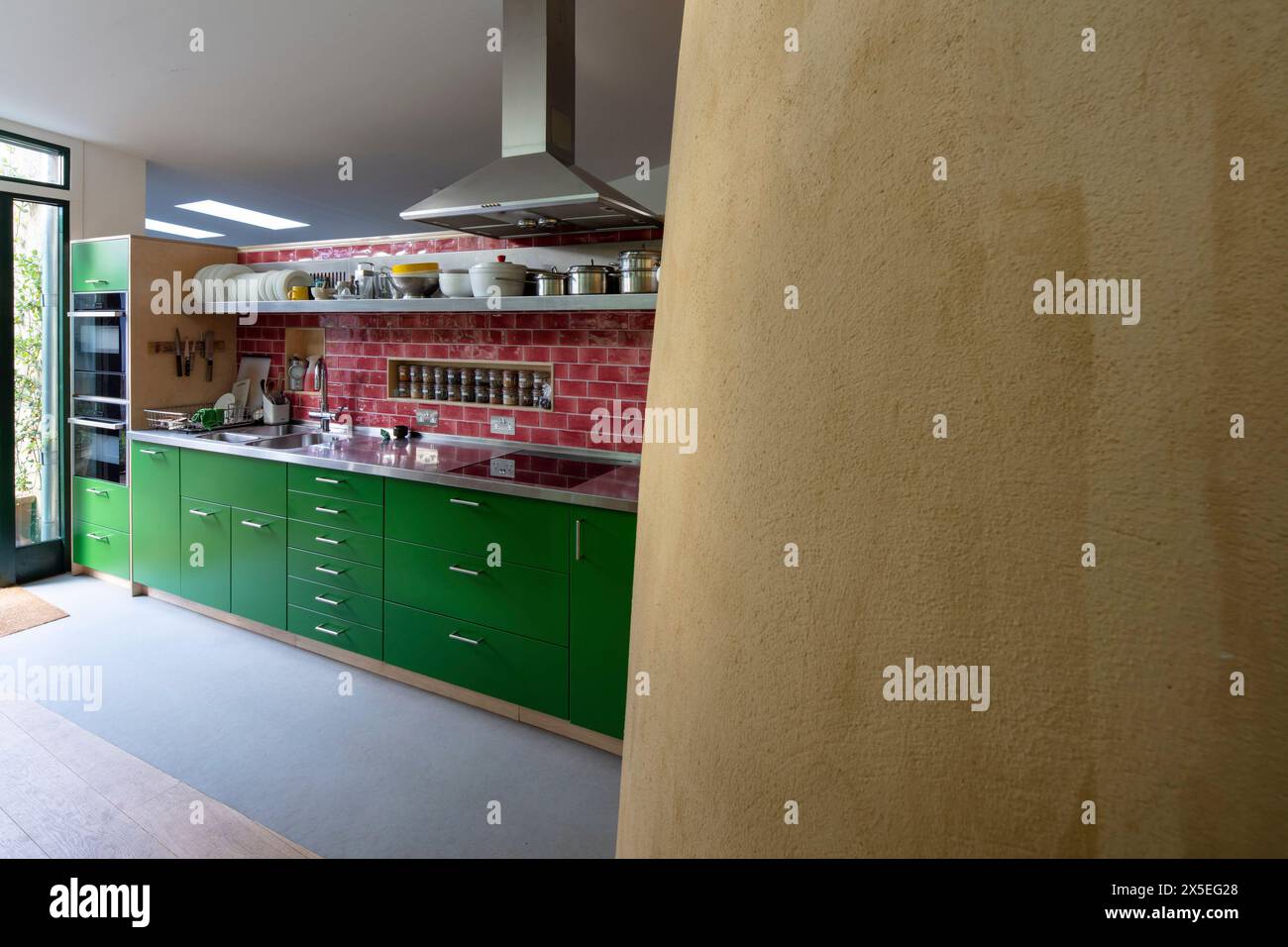 View of the kitchen range with the sculptural larder on the right ...
