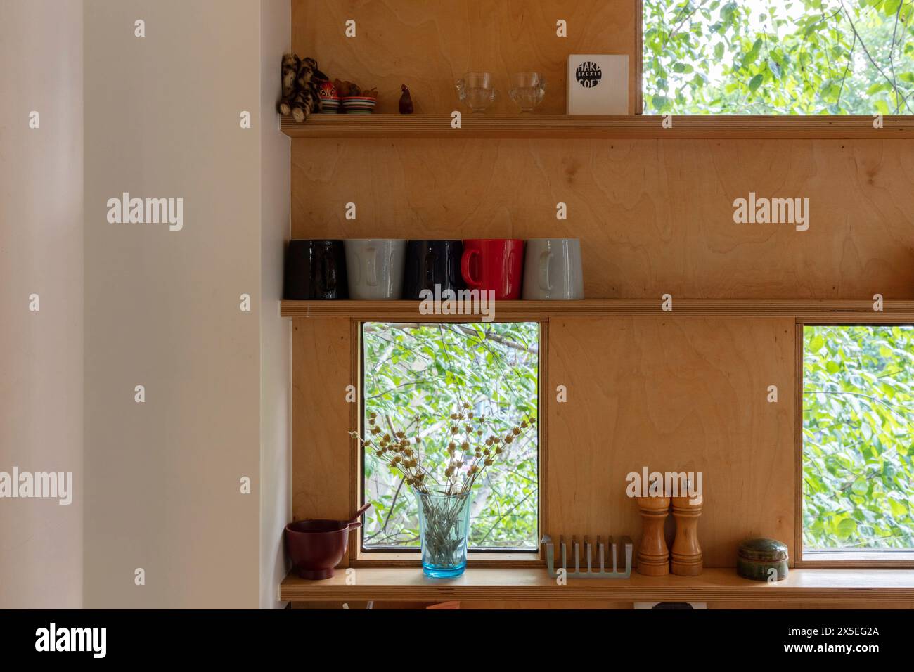 Different shaped windows run down the side of the kitchen area. Straw ...