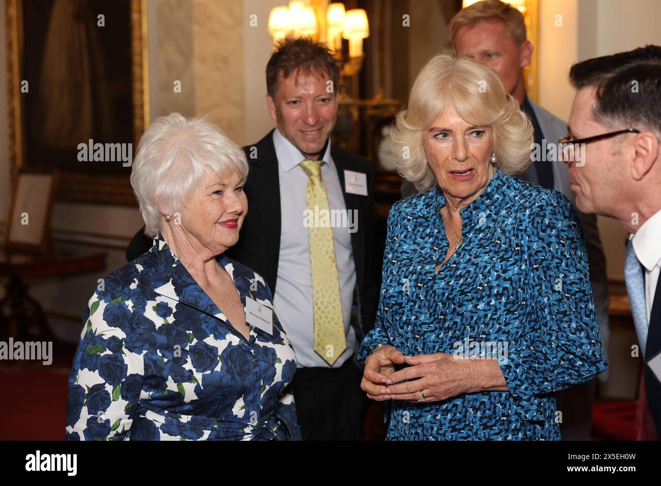 Queen Camilla speaks to actress Annette Badland as she hosts a ...
