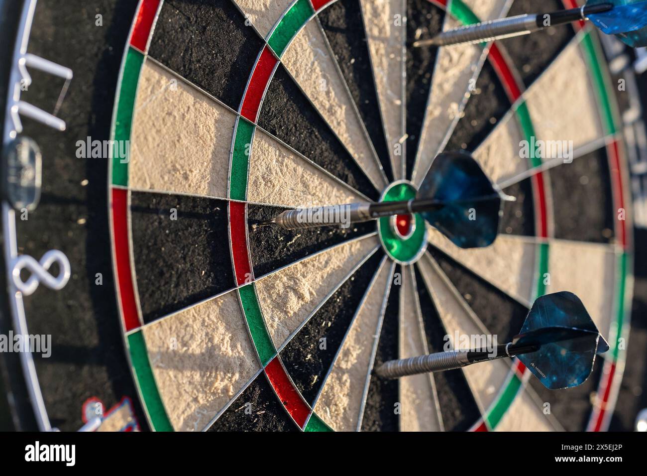 A close up portrait of a dartboard game outside on a sunny day, with ...