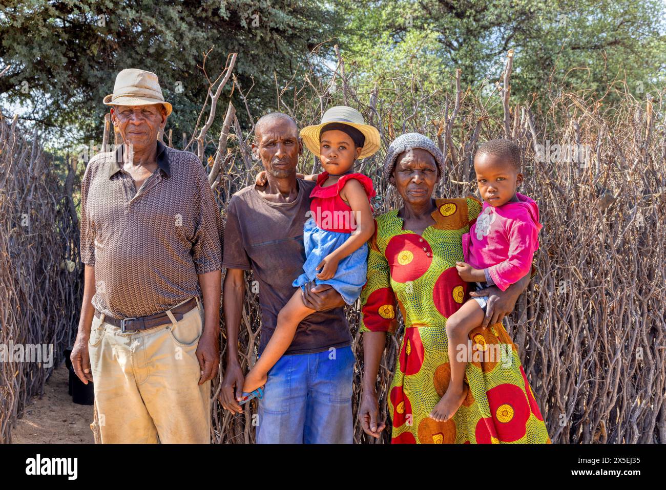 African village, large family standing parents and kids in front of the ...