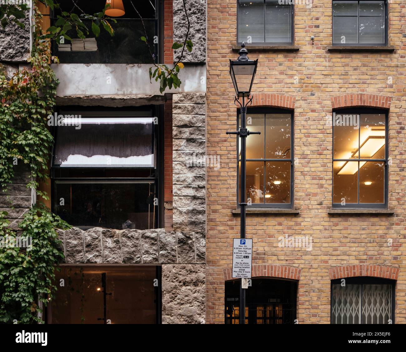Contextual view of square windows and limestone frame contrasting with ...