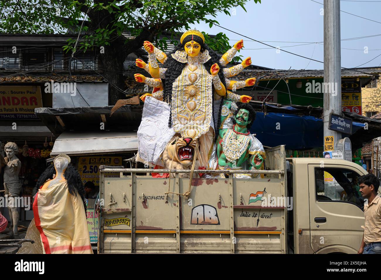 Idol of Goddess Devi Durga is being loaded onto the mini truck for the ...