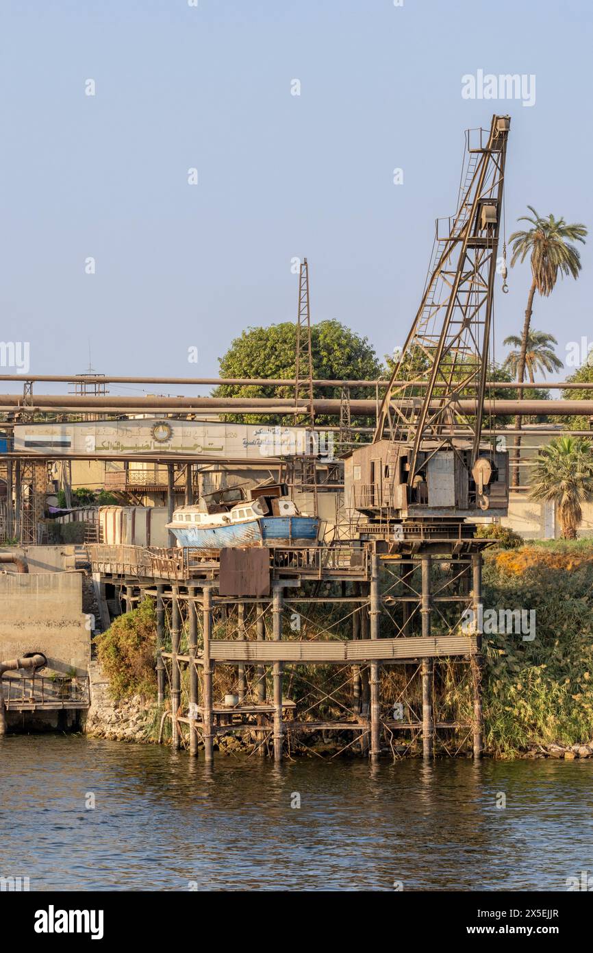 Boat yard with a pier mounted derrick for lifting boats into and out of ...