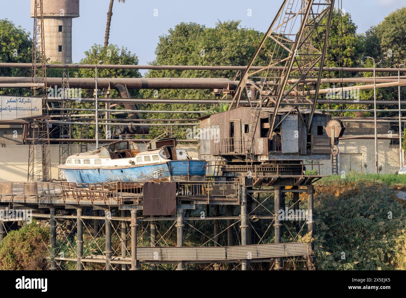Boat yard with a pier mounted derrick for lifting boats into and out of ...