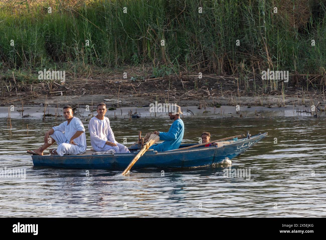 Local Egyptians fishing on the Nile River in Egypt. Small row boats are ...