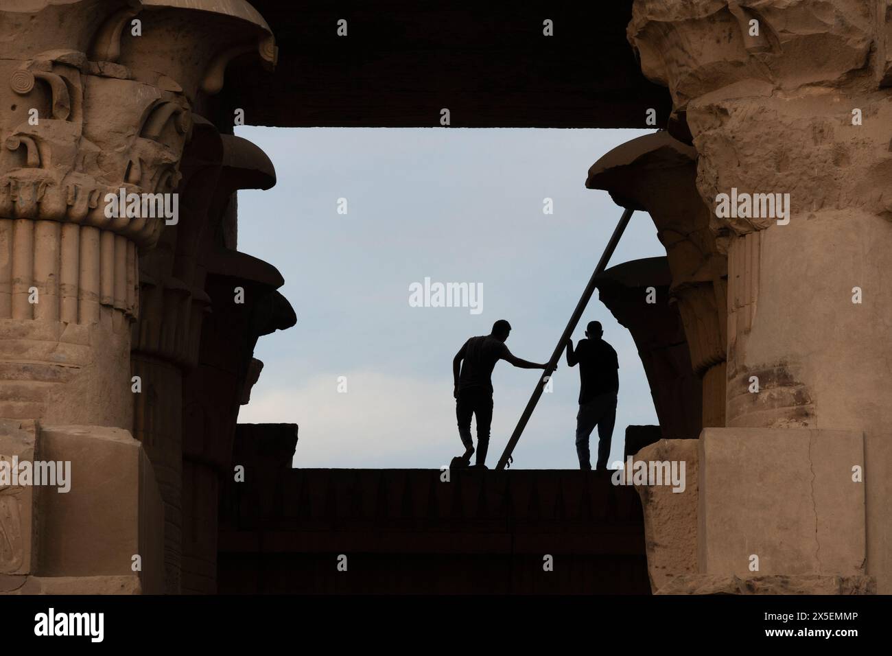 Workers with ladder carrying out conservation work at the Ptolemaic-era ...