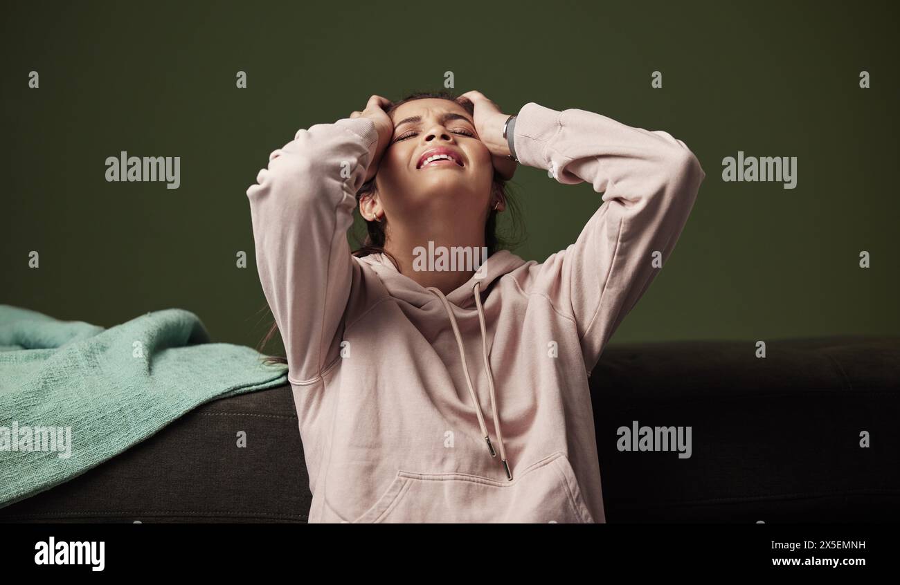 Woman, frustrated and crying on sofa for mental health with anxiety ...