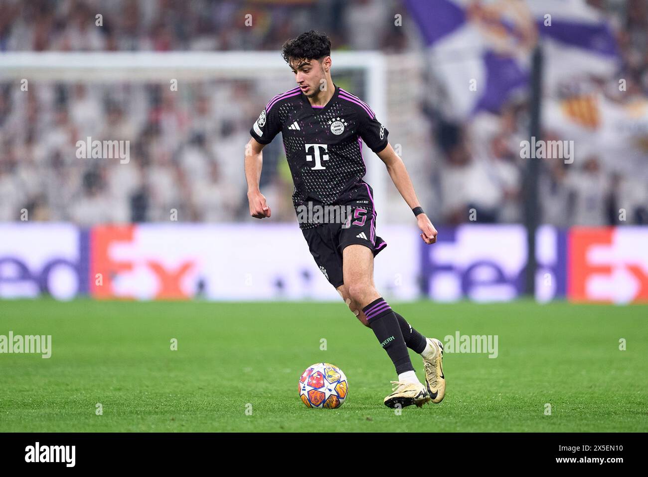 Aleksandar Pavlovic of FC Bayern München runs with the ball during the ...