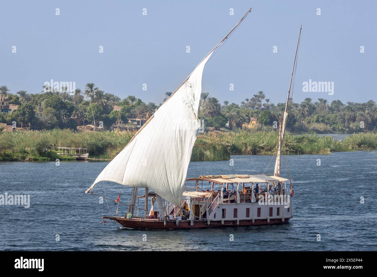 Dahabiya boat Nile River cruiser, with it's traditional two sails. An ...