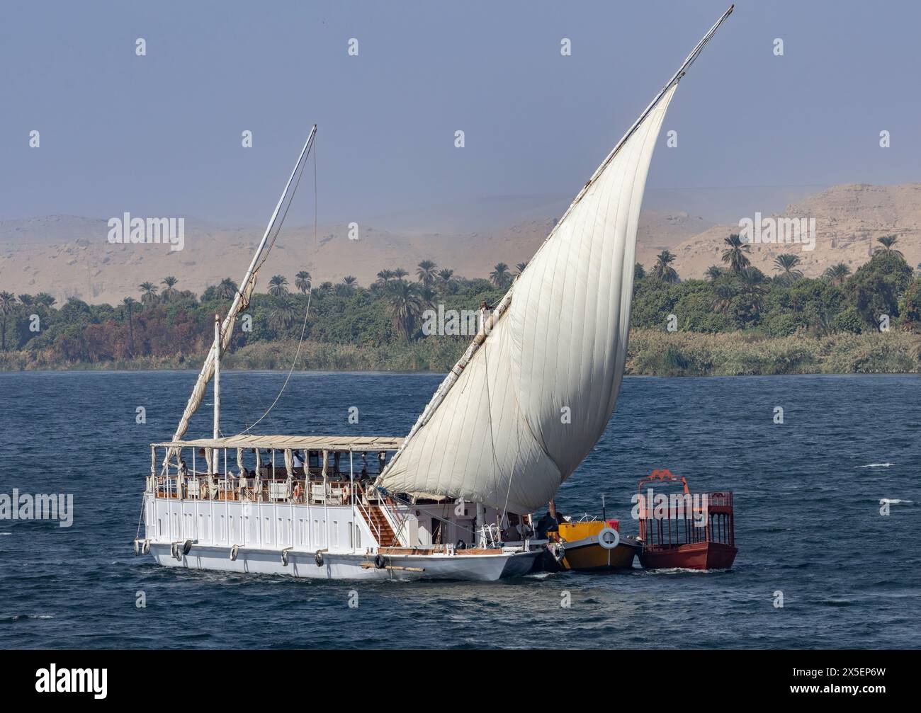 Dahabiya boat Nile River cruiser, with it's traditional two sails. An ...