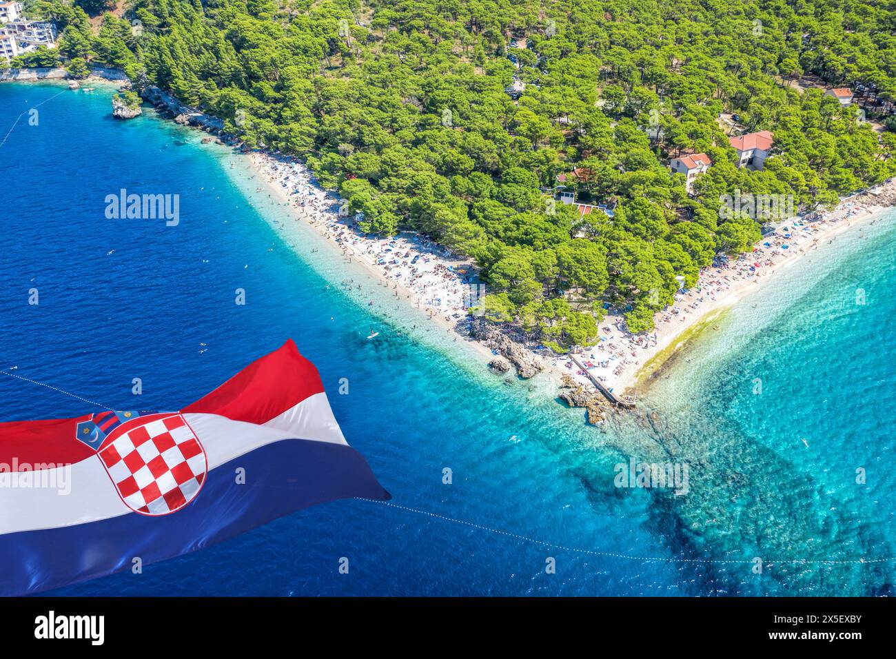 Punta Rata beach with Croatian flag against Adriatic clean sea water ...