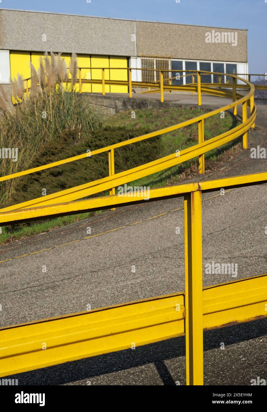 spiral warehouse ramp with yellow railings Stock Photo - Alamy
