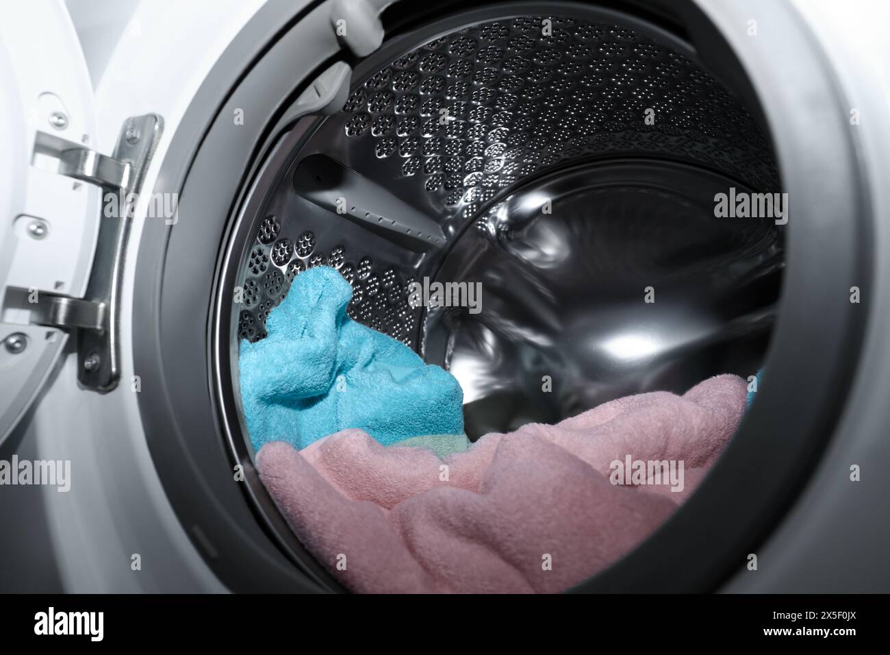 Modern washing machine drum with laundry, closeup Stock Photo - Alamy