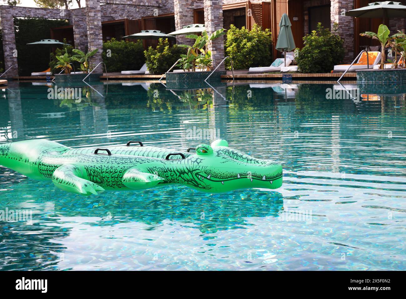 Float in shape of crocodile in swimming pool at luxury resort Stock ...