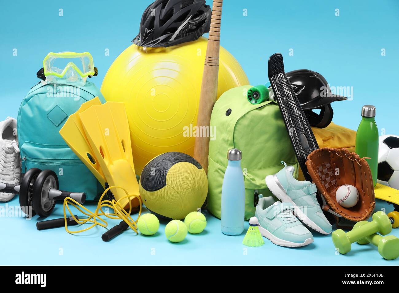 Many different sports equipment on light blue background Stock Photo ...