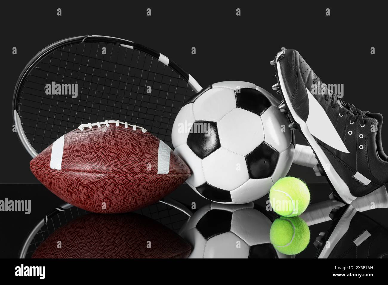 Many different sports equipment on black mirror surface Stock Photo - Alamy