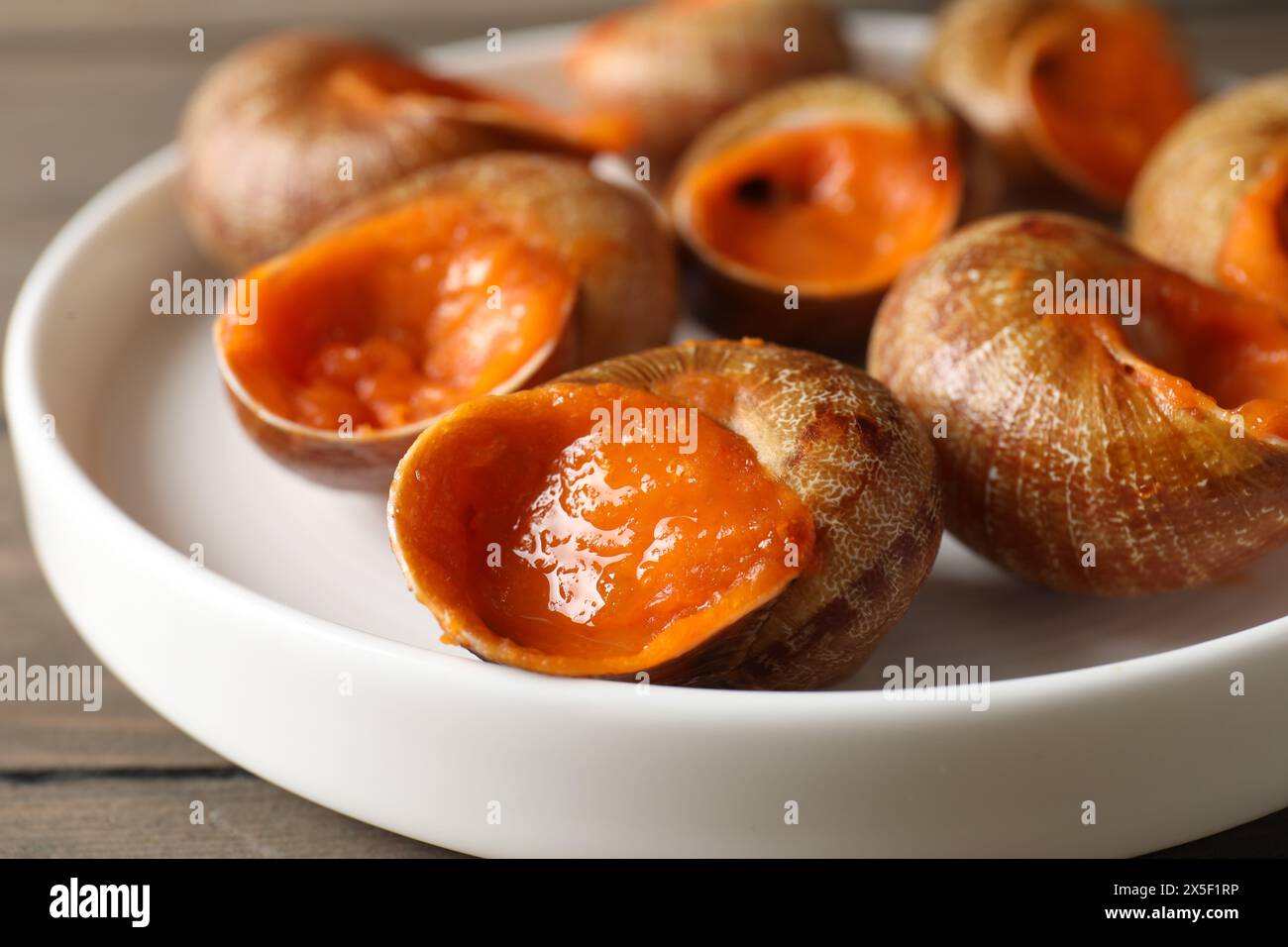 Delicious cooked snails on table, closeup view Stock Photo - Alamy