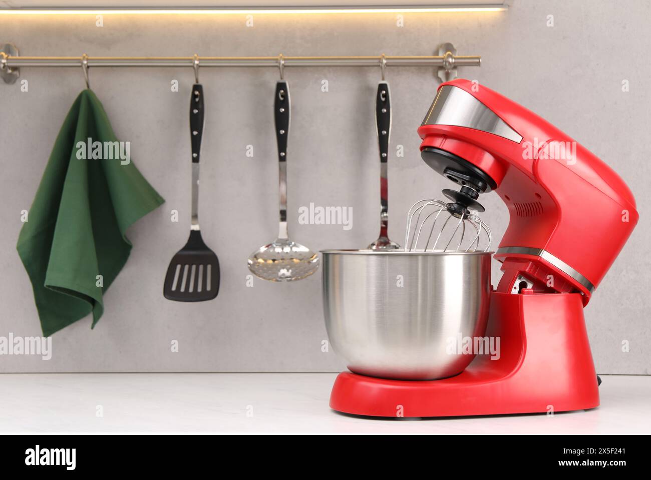 Modern red stand mixer on white table in kitchen Stock Photo - Alamy