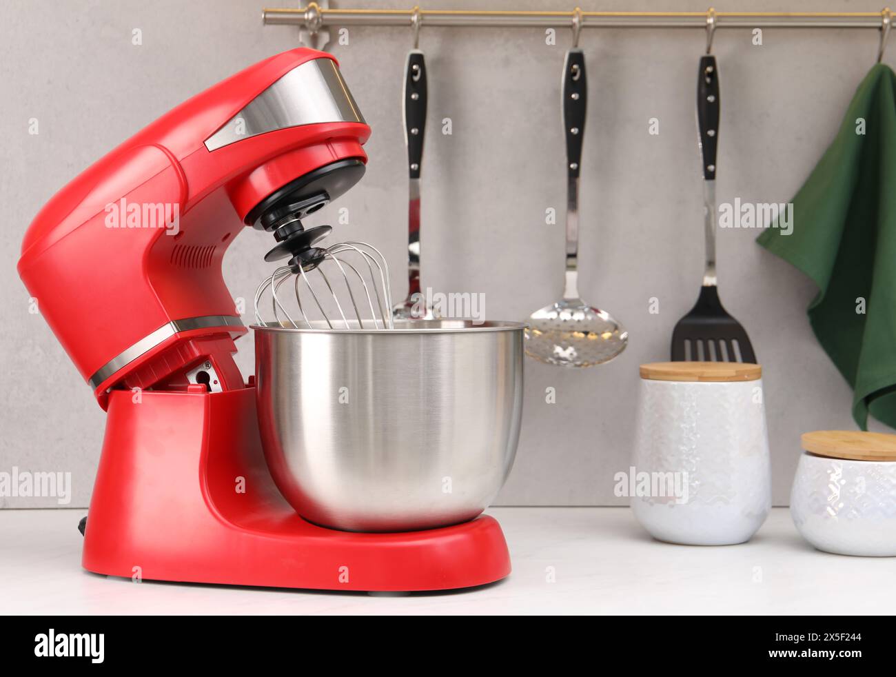 Modern red stand mixer on white table in kitchen Stock Photo - Alamy