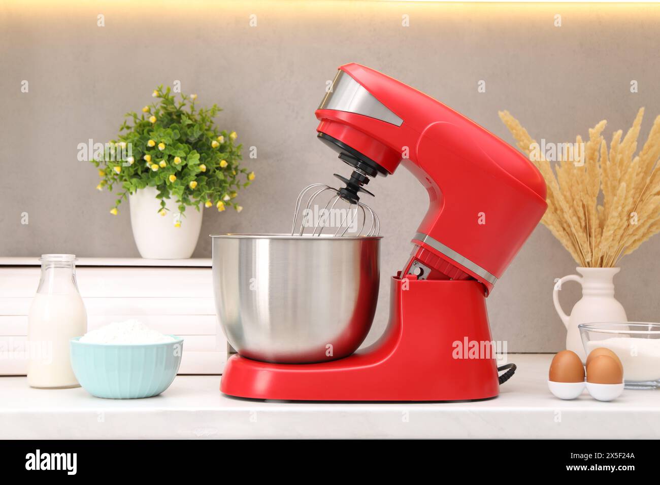 Modern red stand mixer and products on white table in kitchen Stock ...