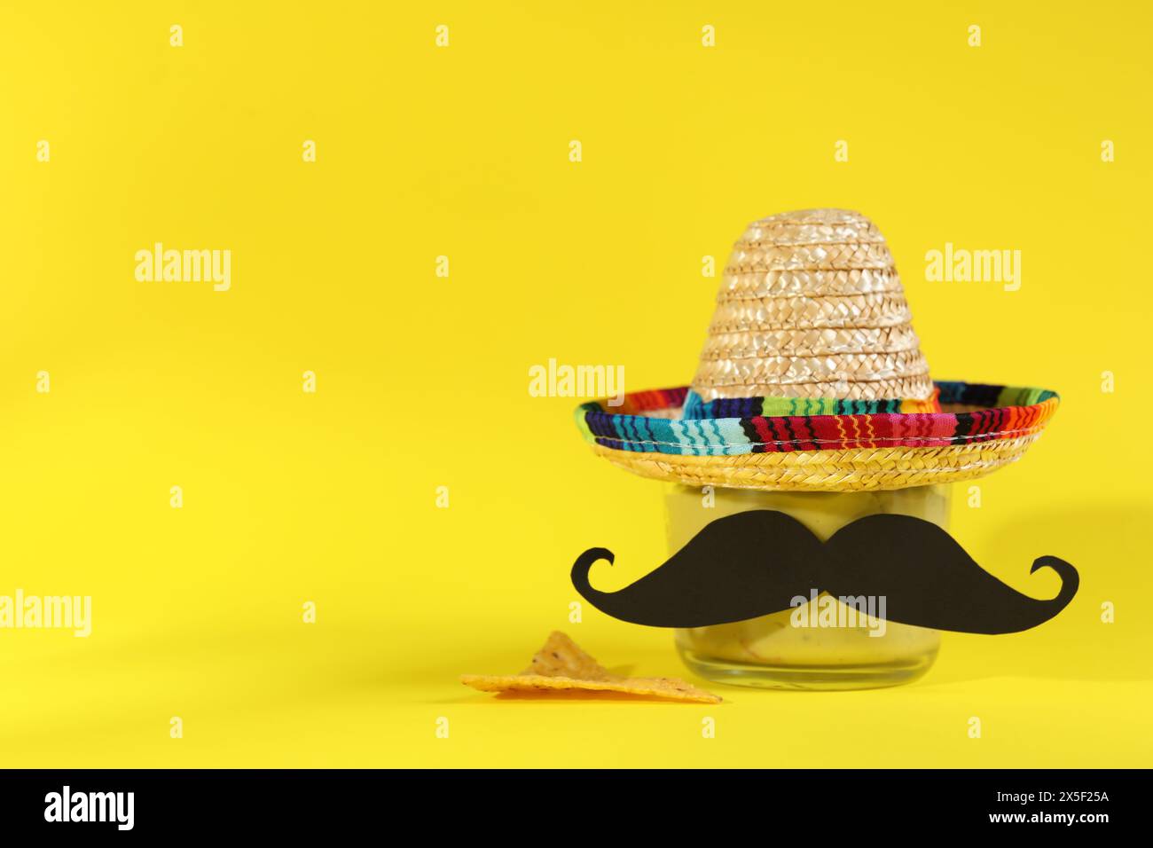 Delicious guacamole, nachos chip, Mexican sombrero hat and fake ...