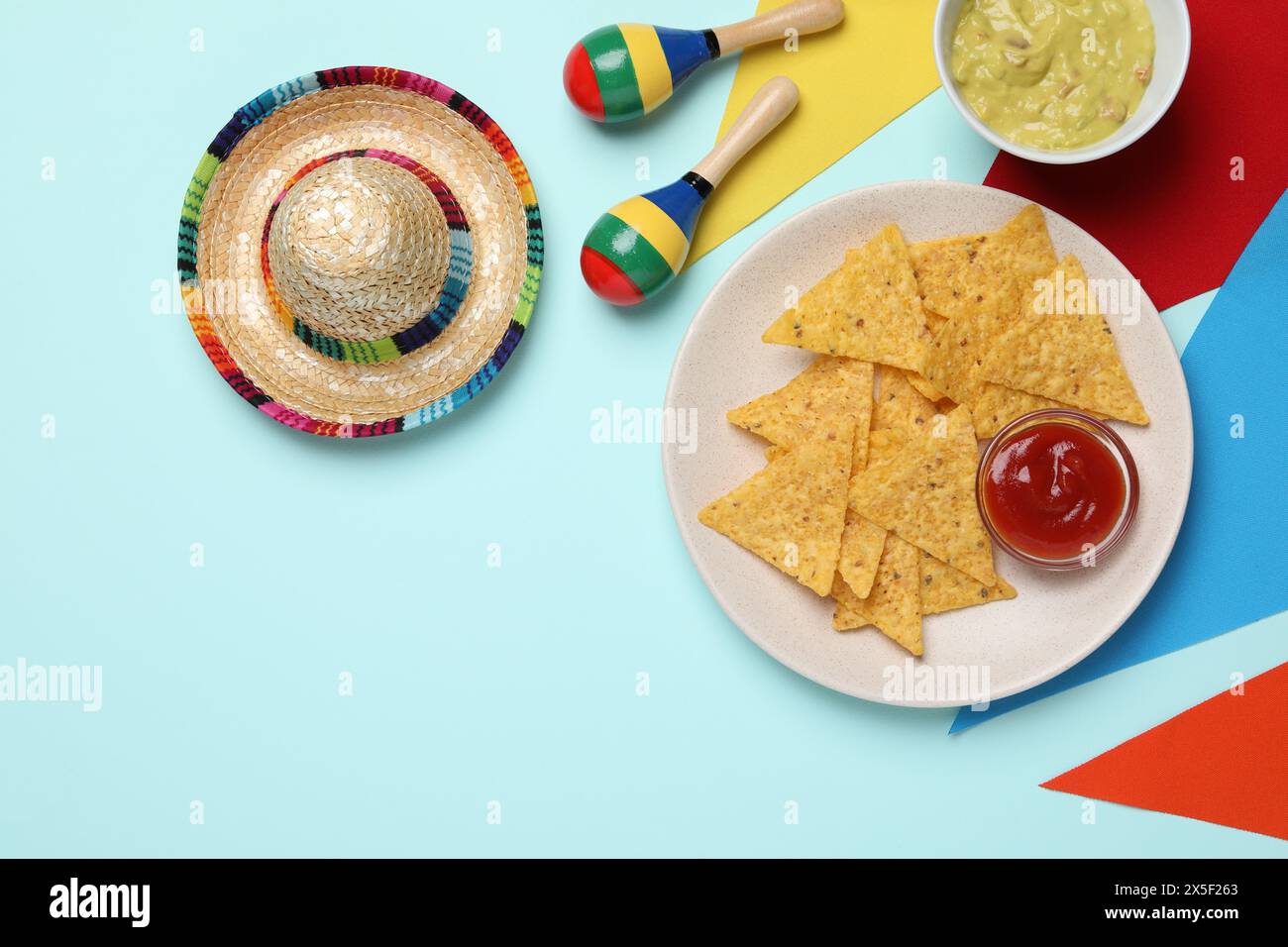 Flat lay composition with nachos chips and Mexican sombrero hat on ...