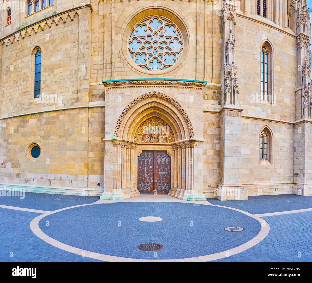 The rose window and carved arched front gate of Matthias Church ...